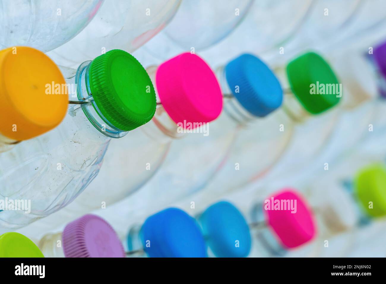 Beautiful wall made of multi colored recycled plastic bottles. Bottle ...