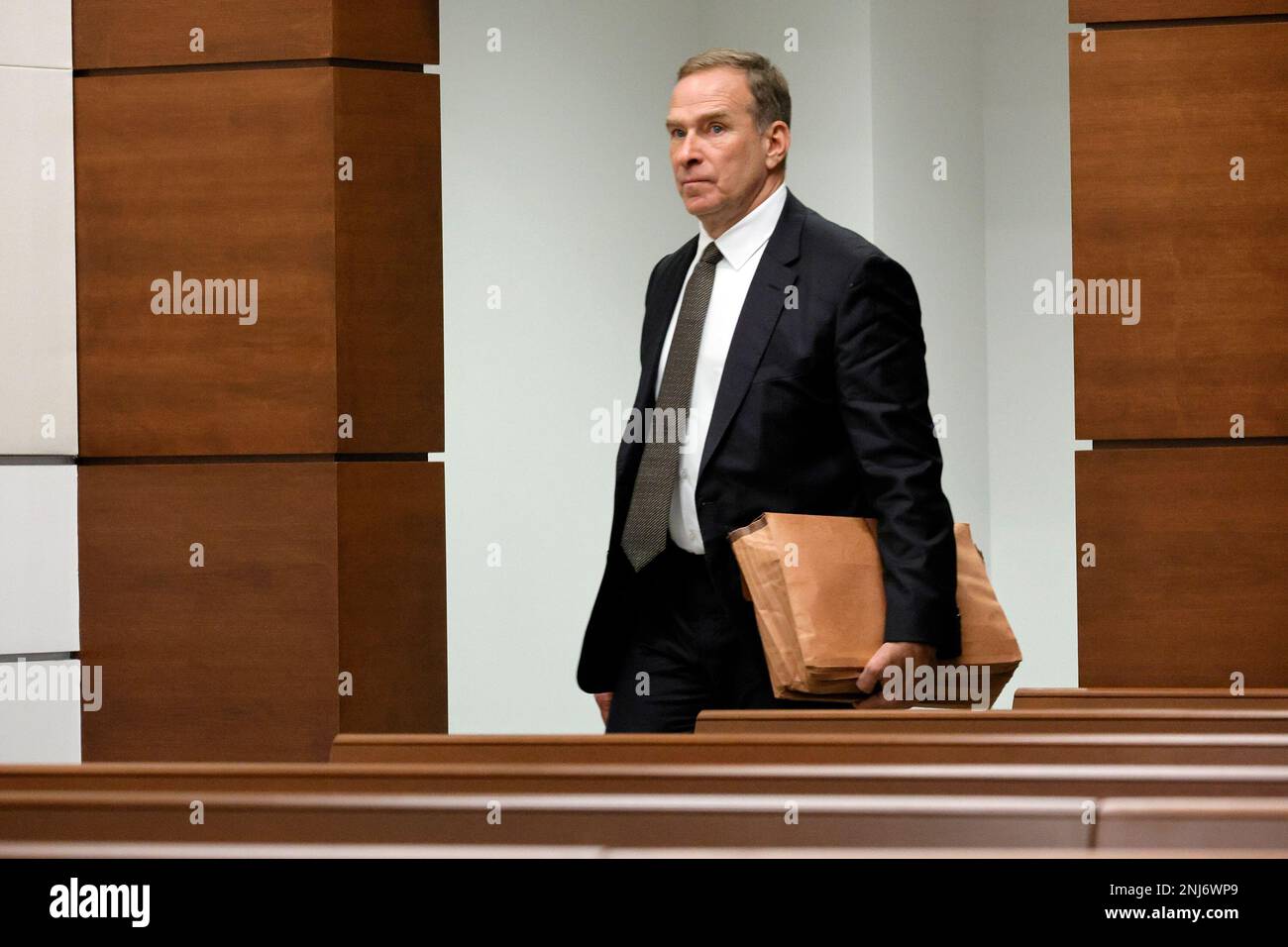 Forensic psychologist Dr. Charles Scott enters the courtroom to ...