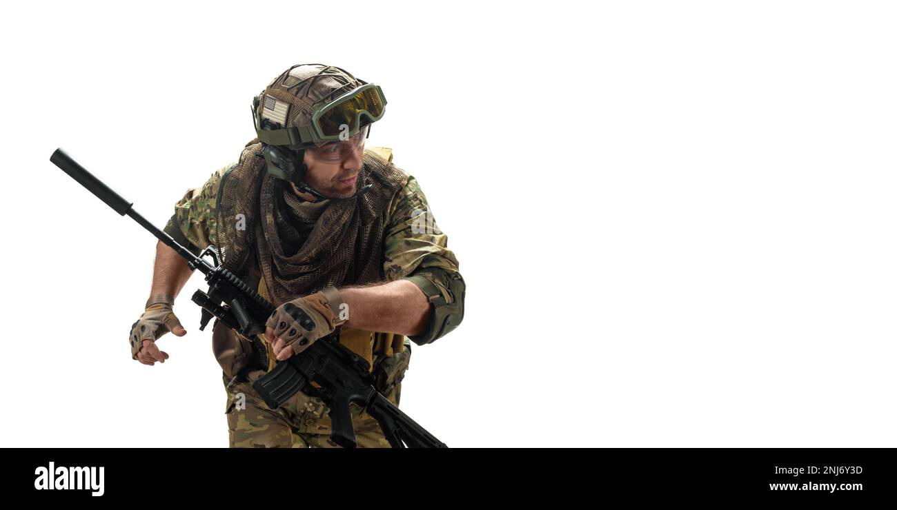Army soldier with an automatic rifle looks back while running. Isolated ...
