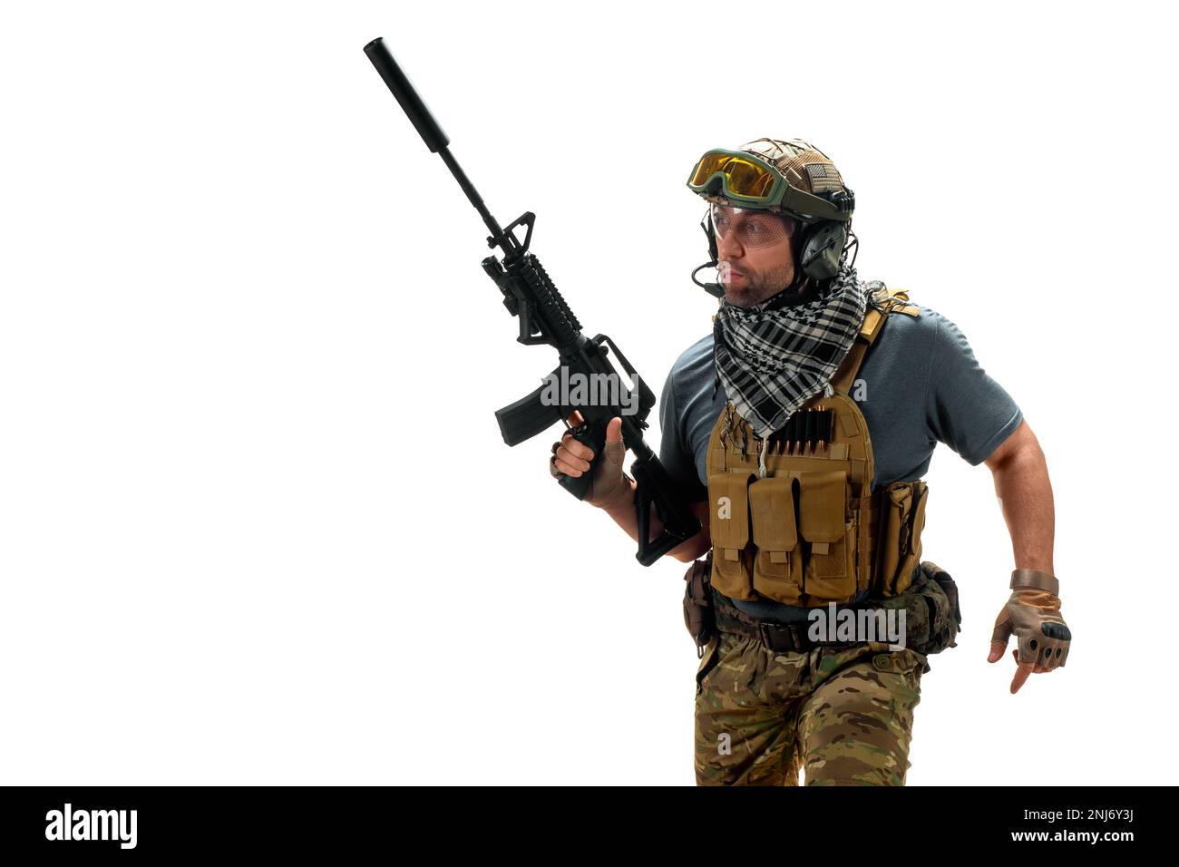 Army soldier during a special operation walks with an automatic rifle ...