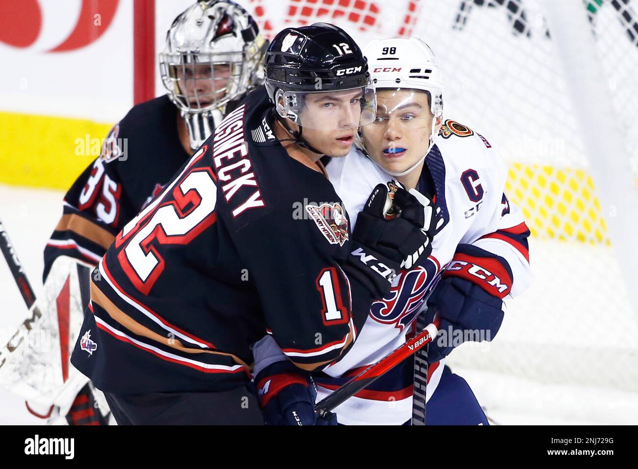 Regina Pats player Connor Bedard, rt, battles with Calgary Hitmen player Vojtech Husinecky, from ...