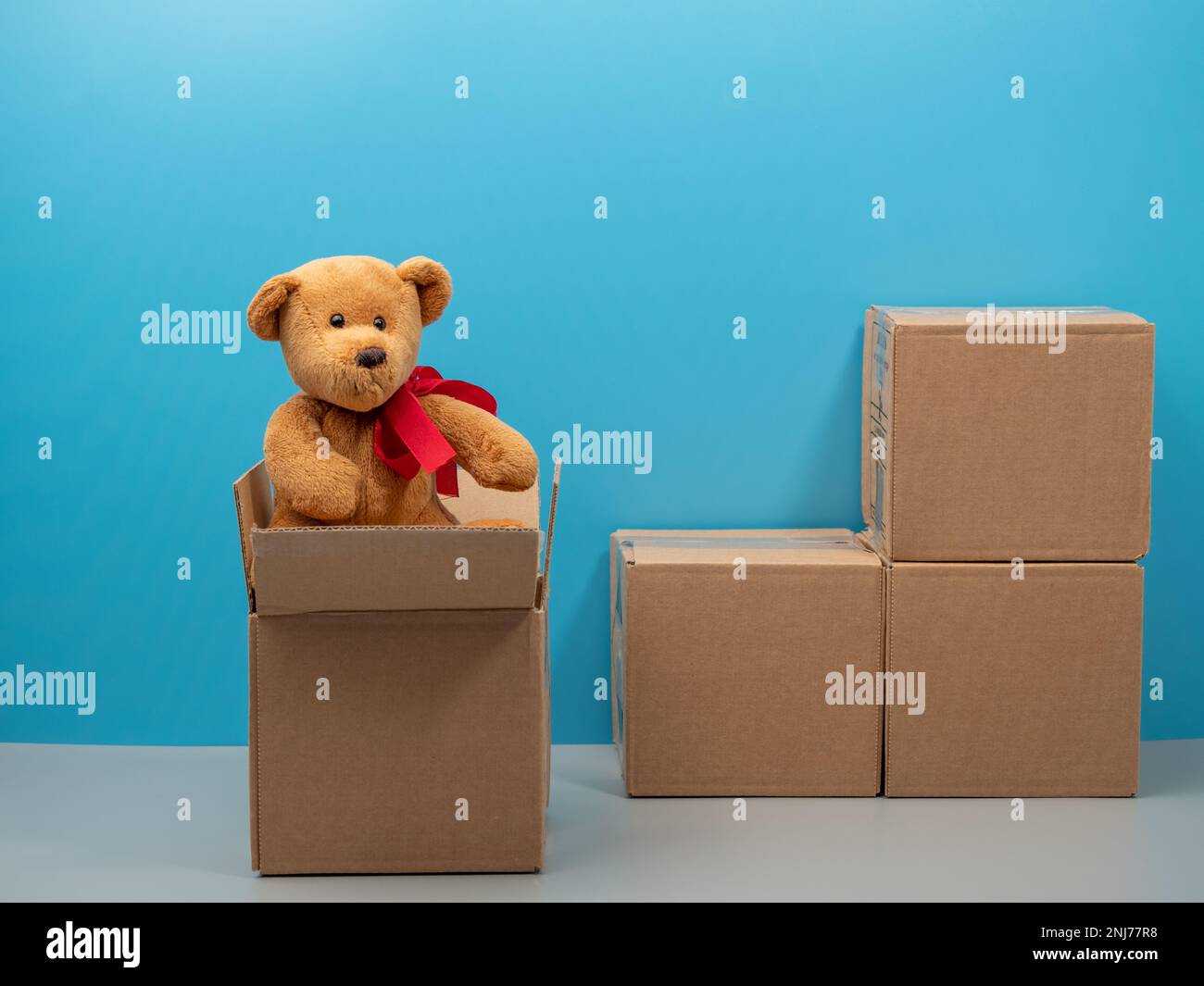 Humanitarian aid. Cardboard boxes with donations on a blue background ...