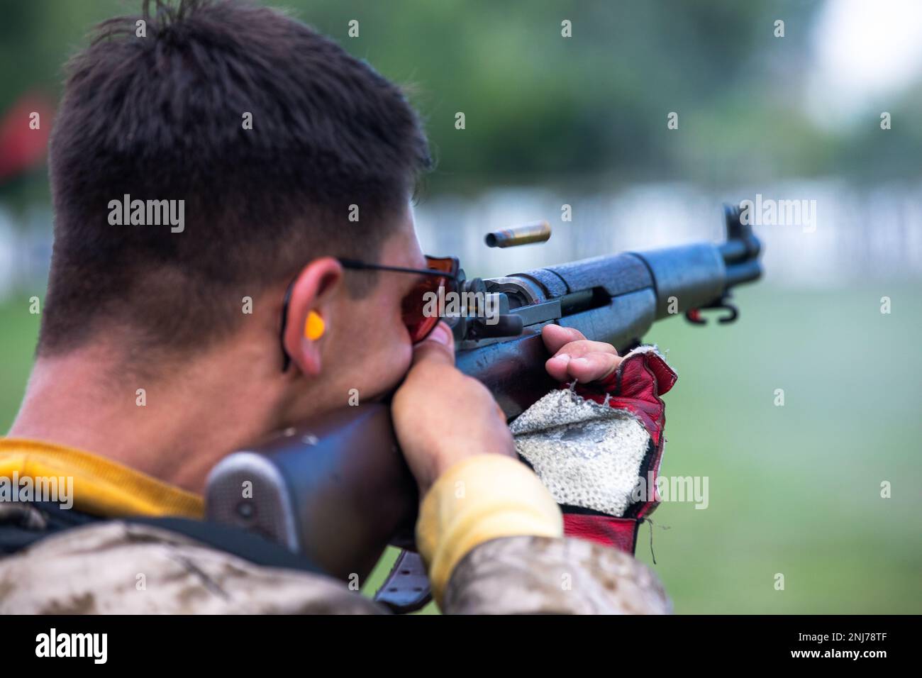 A Marine with the Marine Corps Shooting Team fires his rifle during the ...