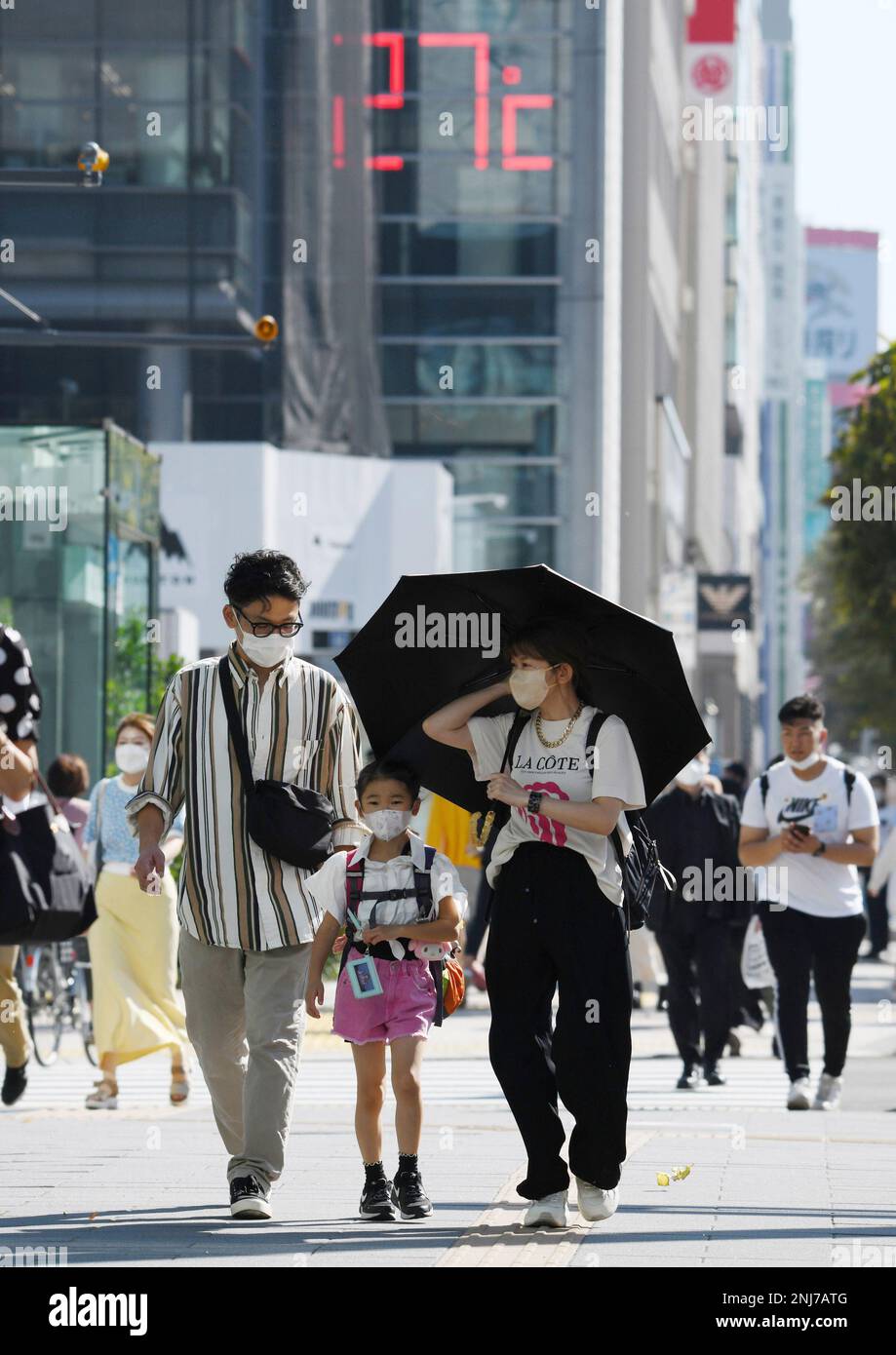 People walk as temperature rises in Sapporo, Hokkaido on Oct. 1, 2022 ...
