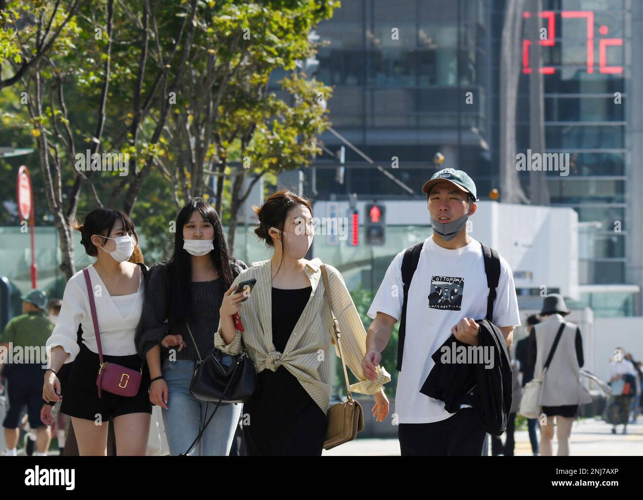 People walk as temperature rises in Sapporo, Hokkaido on Oct. 1, 2022 ...