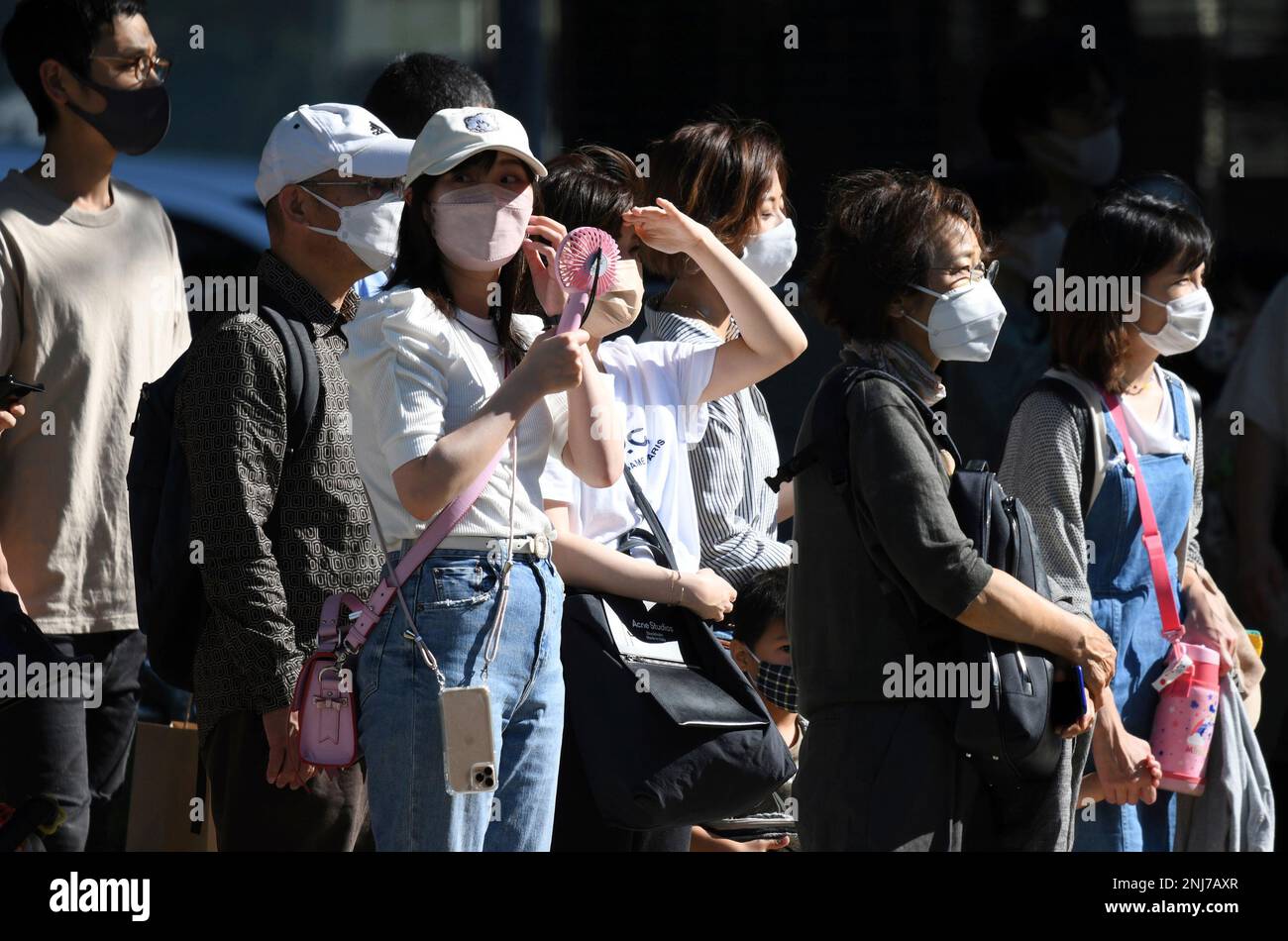 People walk as temperature rises in Sapporo, Hokkaido on Oct. 1, 2022 ...