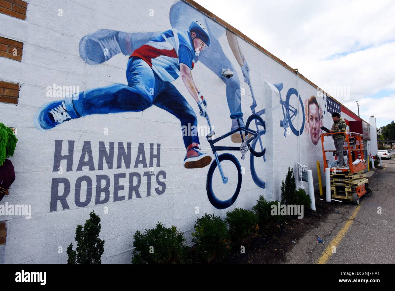 Artist Jeff Zimmermann works on a mural of Olympian Hannah Roberts, Thursday, Sept. 29, 2022, on ...