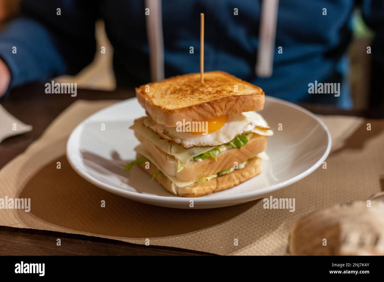 Vegetarian club sandwich with white bread, egg, green lettuce and ...