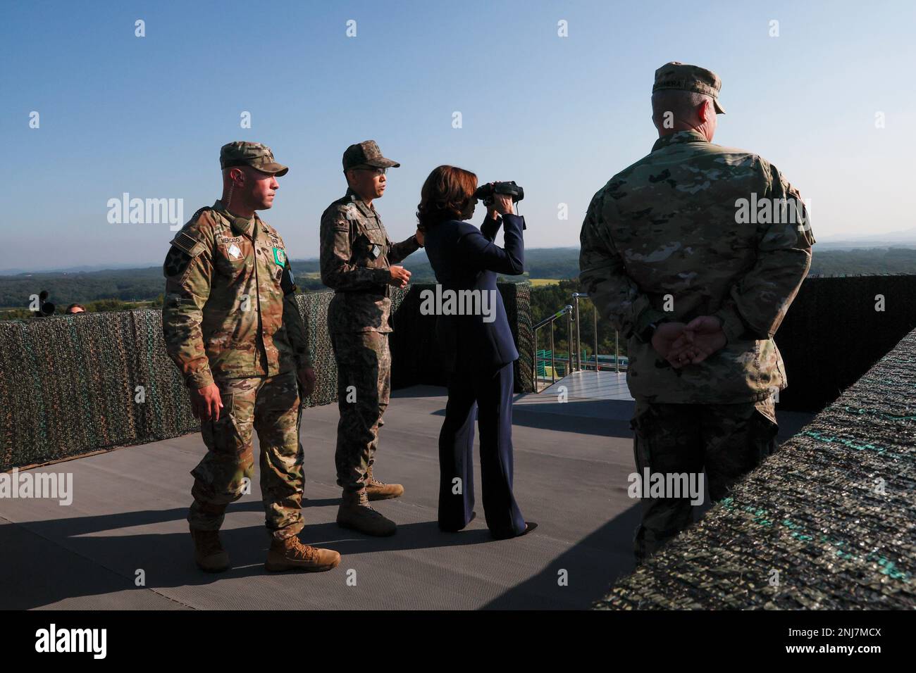 U.S. Vice President Kamala Harris, center right, uses binoculars at the ...