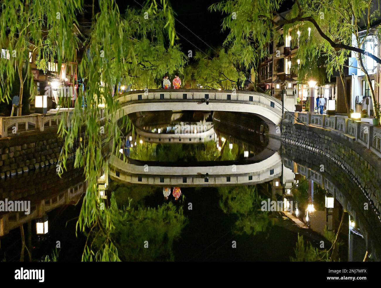 A photo shows a bridge over Ohtani River at Kinosaki Onsen (hot spring ...