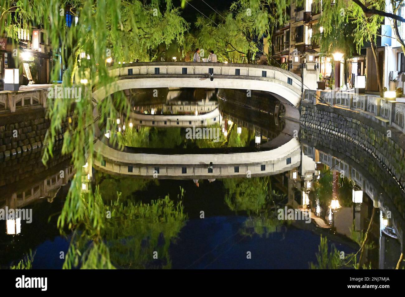 A photo shows a bridge over Ohtani River at Kinosaki Onsen (hot spring ...