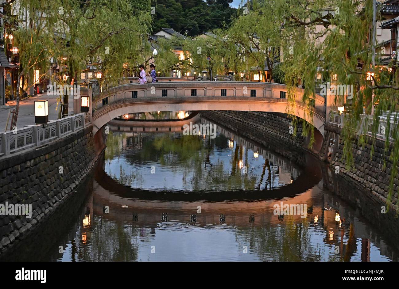 A photo shows a bridge over Ohtani River at Kinosaki Onsen (hot spring ...