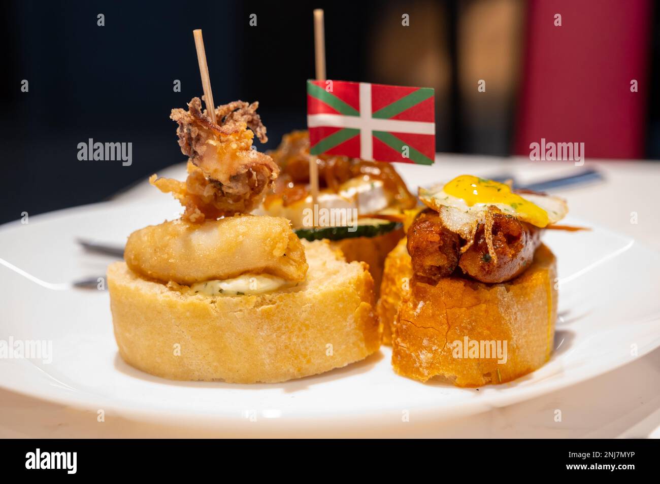 White board with typical snack and flag of Basque Country, pinchos or ...