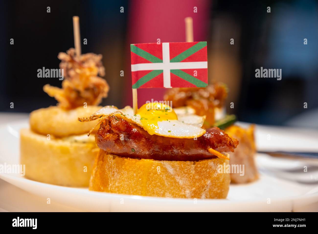 White board with typical snack and flag of Basque Country, pinchos or ...
