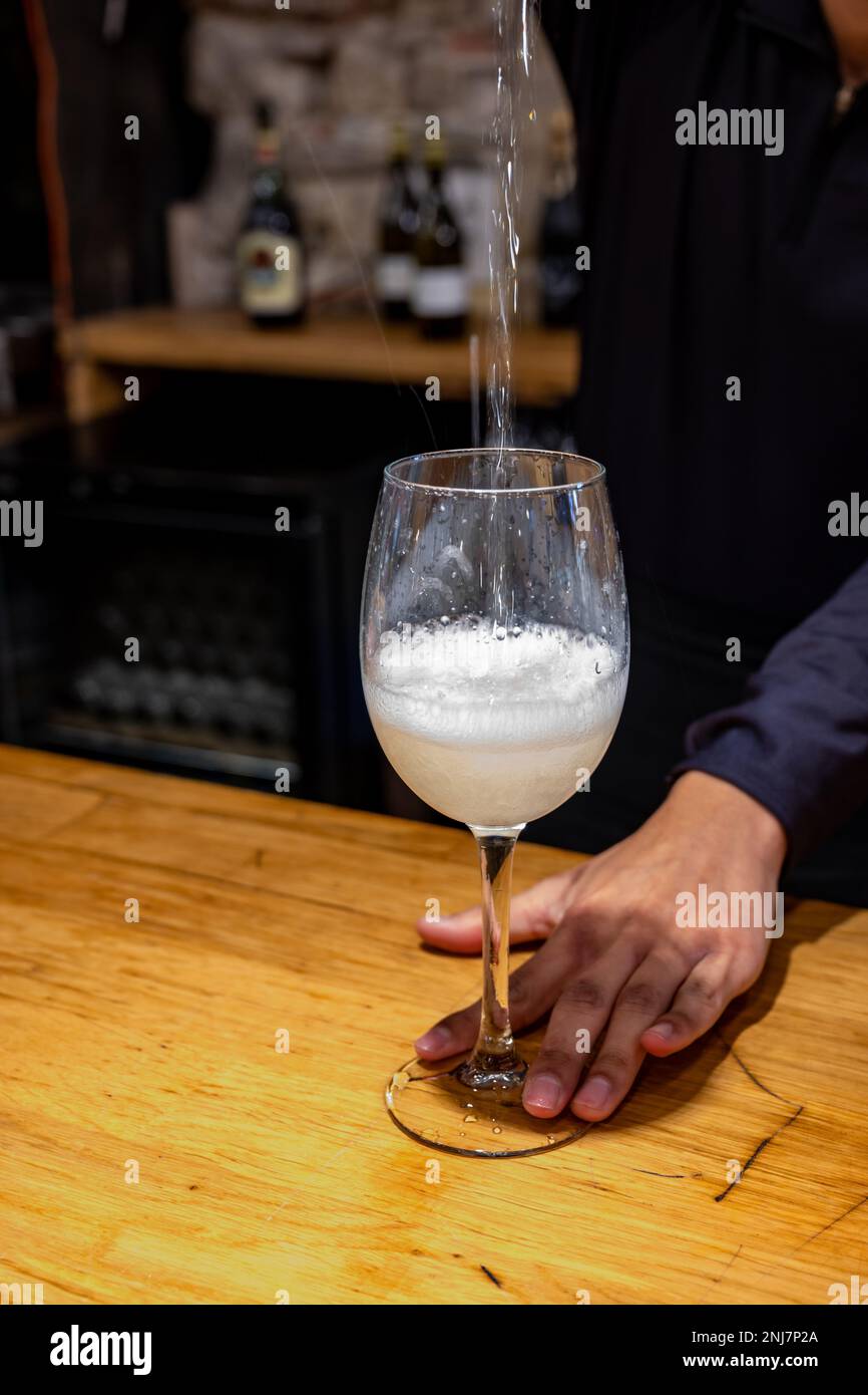 Pouring of txakoli or chacolí slightly sparkling very dry white wine ...