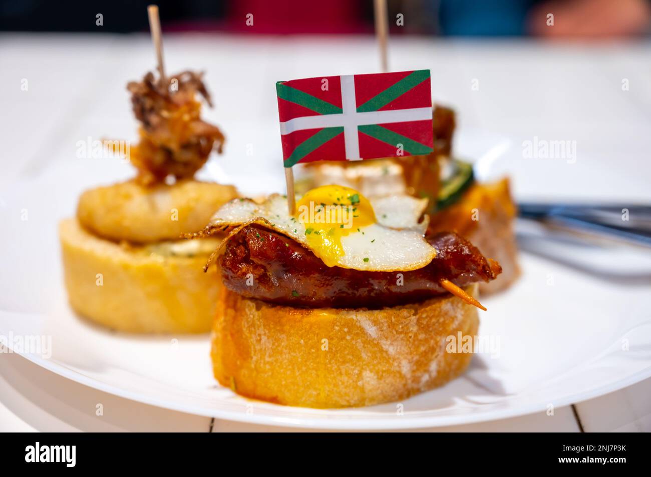 White board with typical snack and flag of Basque Country, pinchos or ...