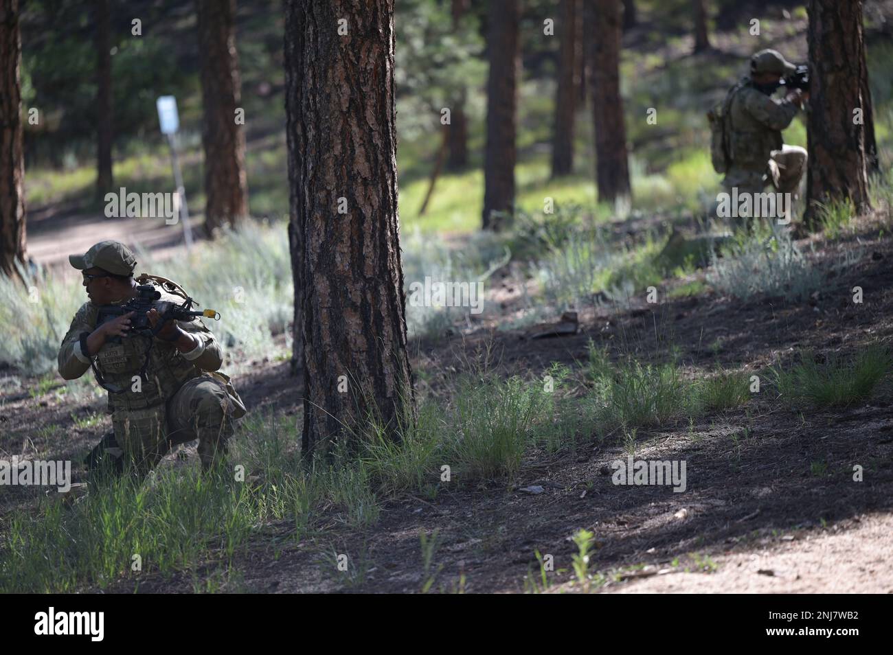 Two members of the 310th Security Forces Squadron take cover behind ...