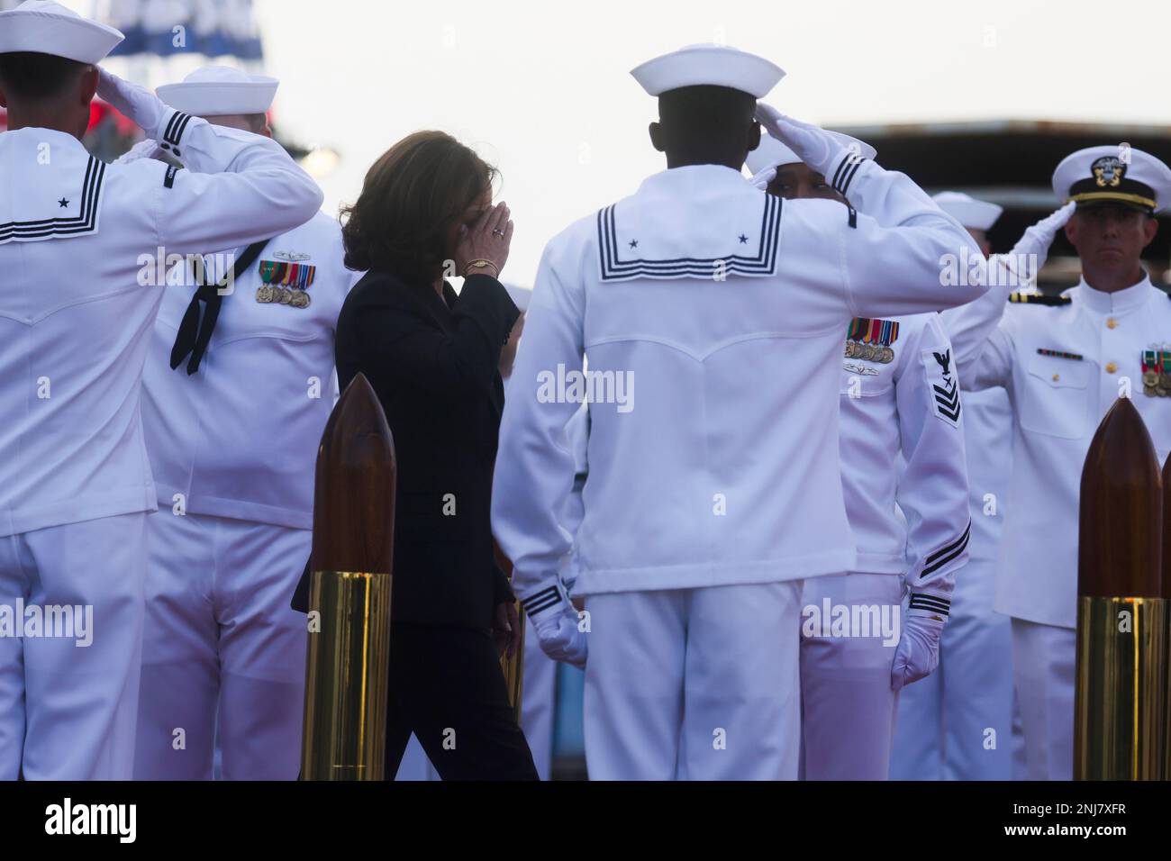 Members of the U.S. Navy salutes U.S. Vice President Kamala Harris as ...