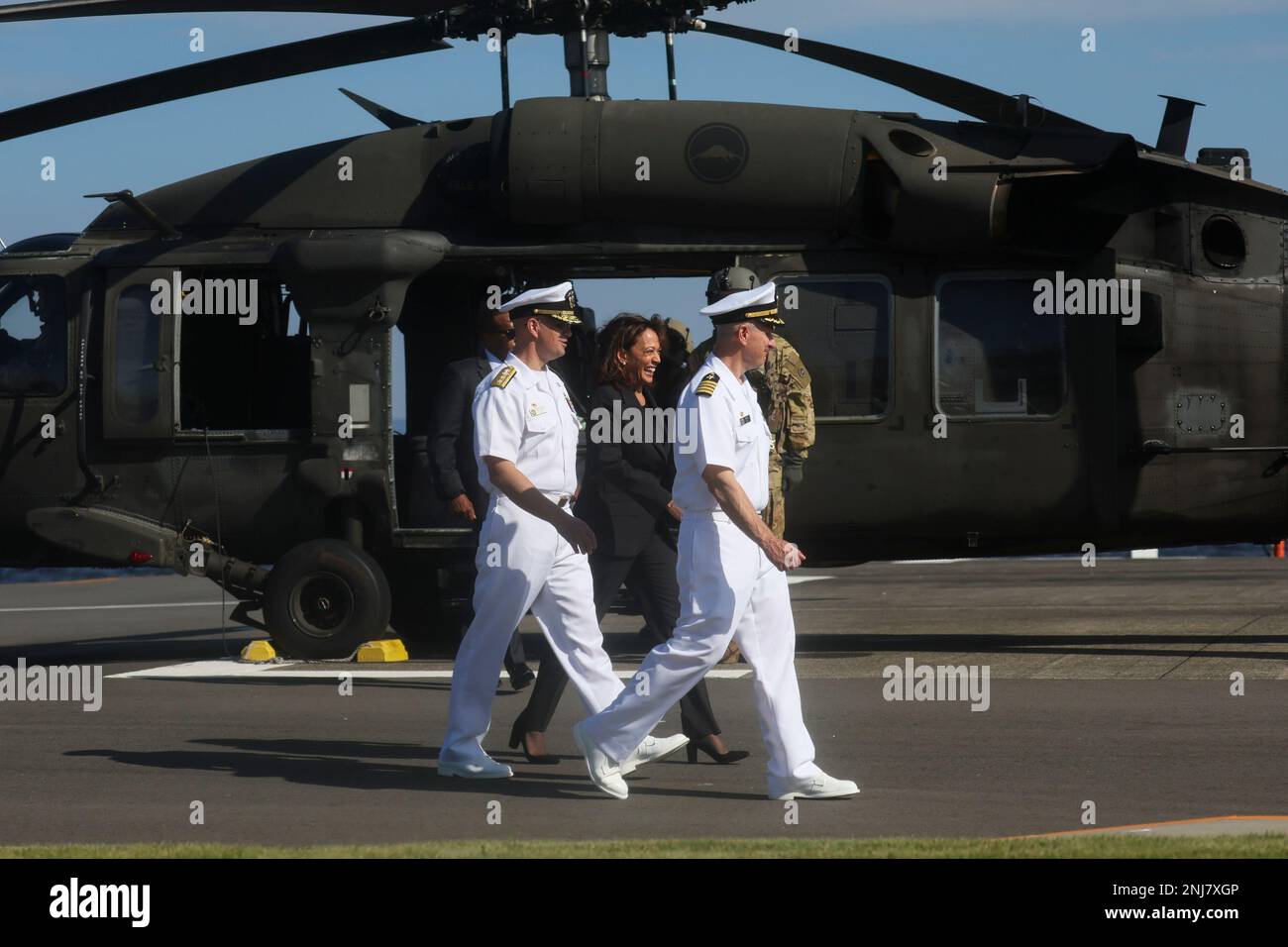 U.S. Vice President Kamala Harris, center, walks with members of the military at the Yokosuka ...