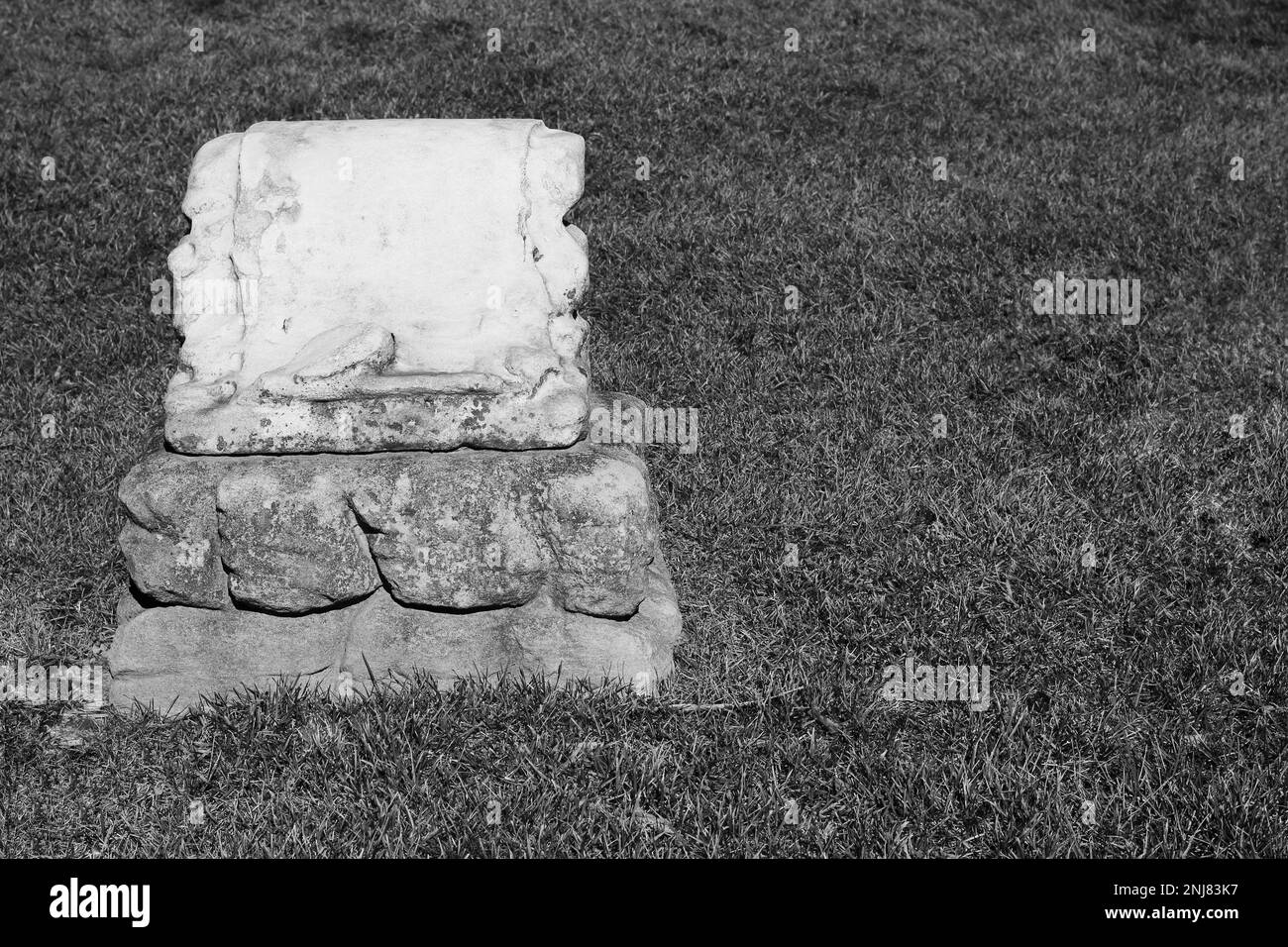 A worn and weathered old tombstone with a blank epitaph and room for ...
