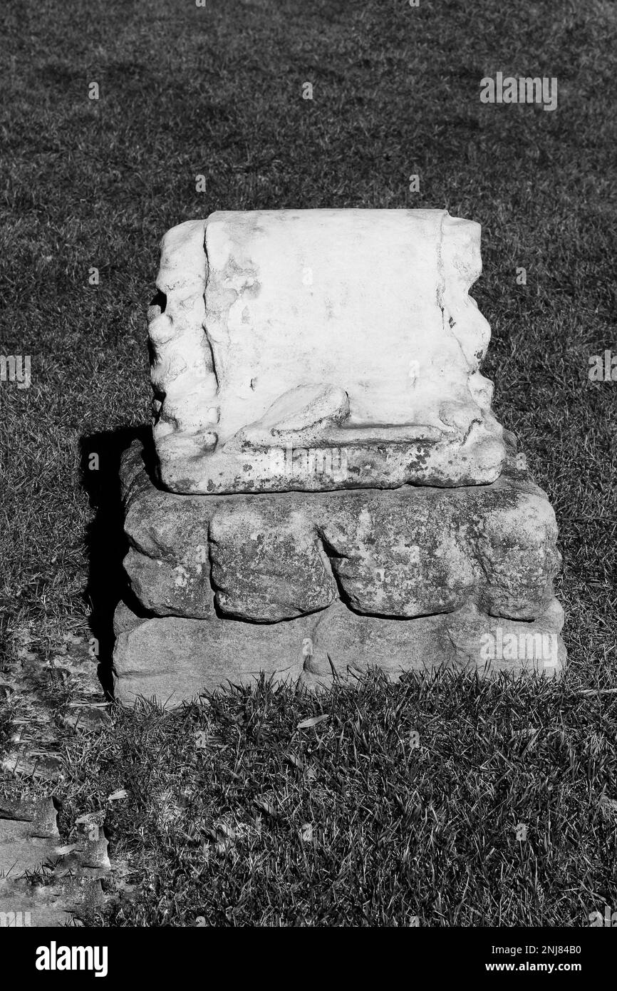 A worn and weathered old tombstone with a blank epitaph and room for ...