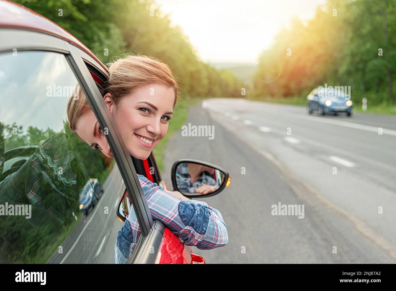 Attractive woman driving a car on a highway Stock Photo - Alamy
