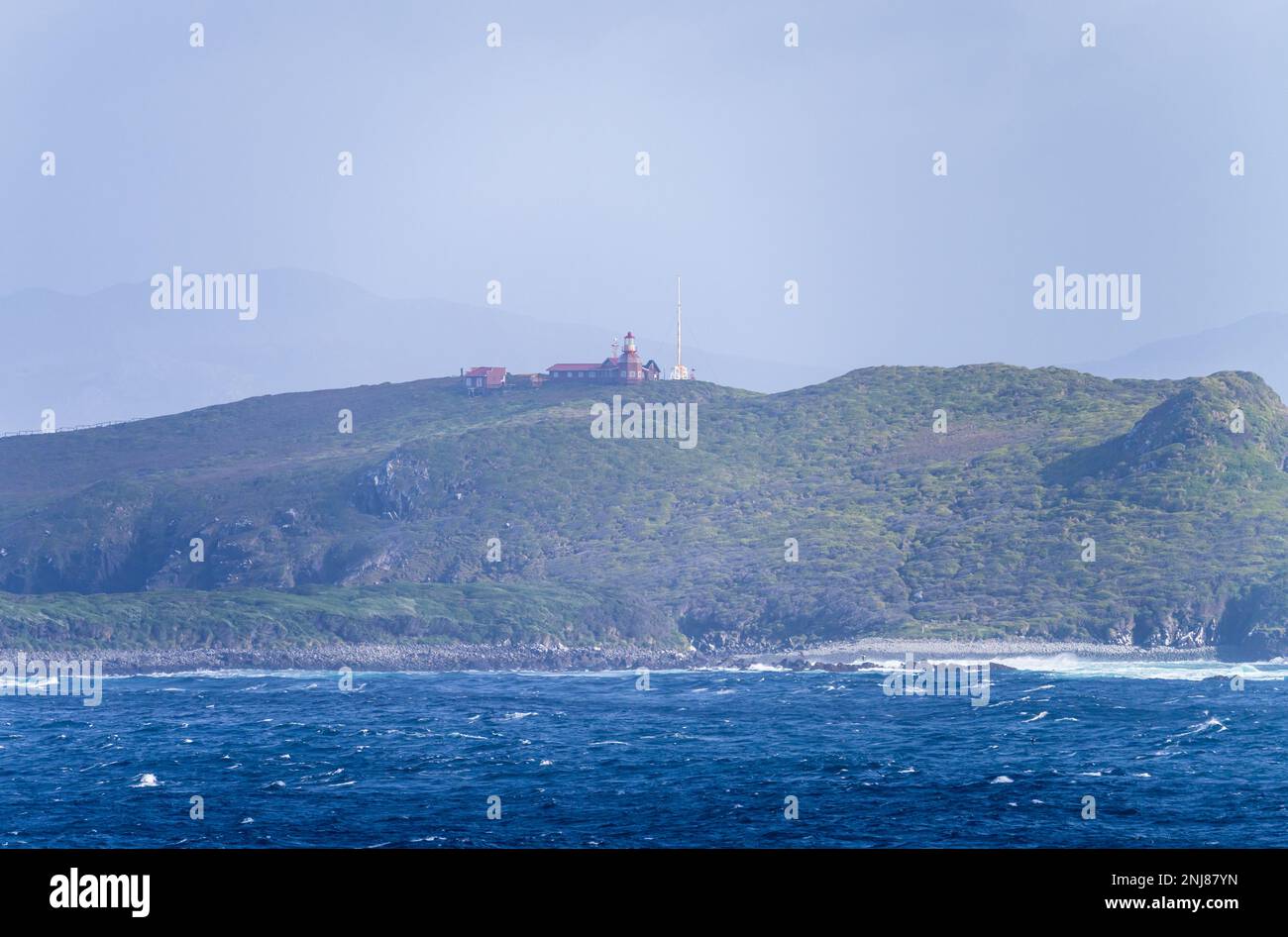 Lighthouse and keepers house on the cliffs of Hornos Island near Cape ...