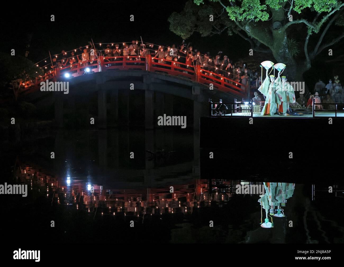 Kagura is performed near the pond on the compound at Dazaifu Tenmangu ...