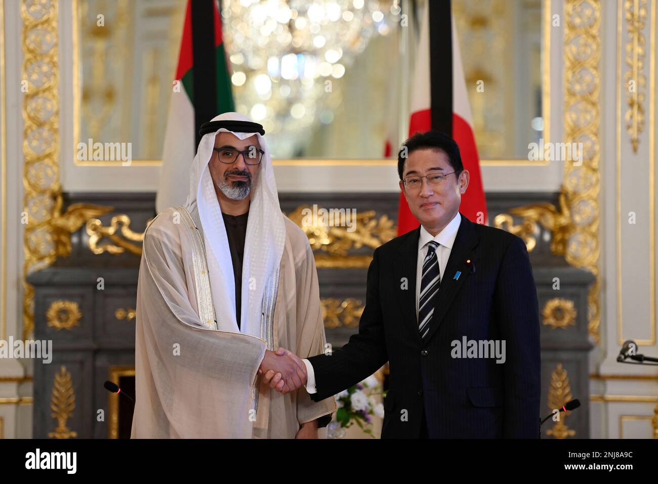 Japan's Prime Minister Fumio Kishida, right, shakes hands with Sheikh ...