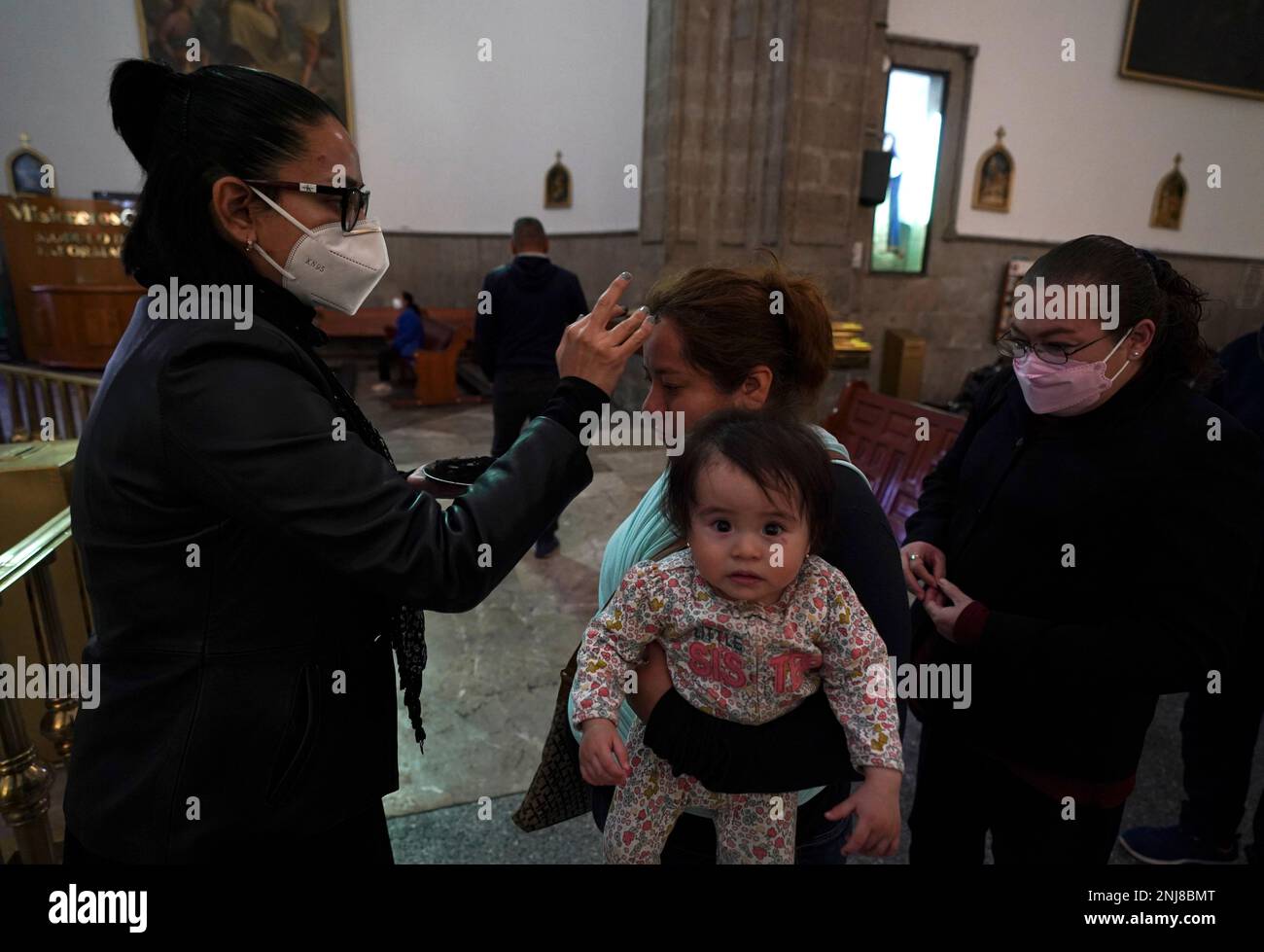 A deaconess marks the forehead of a parishioner with an ash cross ...