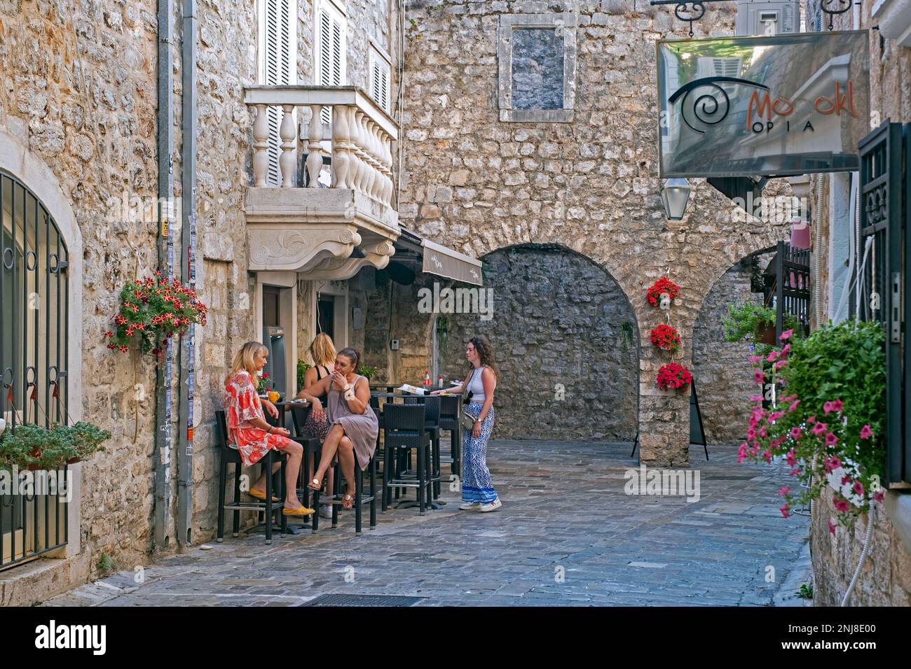 Montenegrin locals having a drink outside café in the medieval Old Town ...