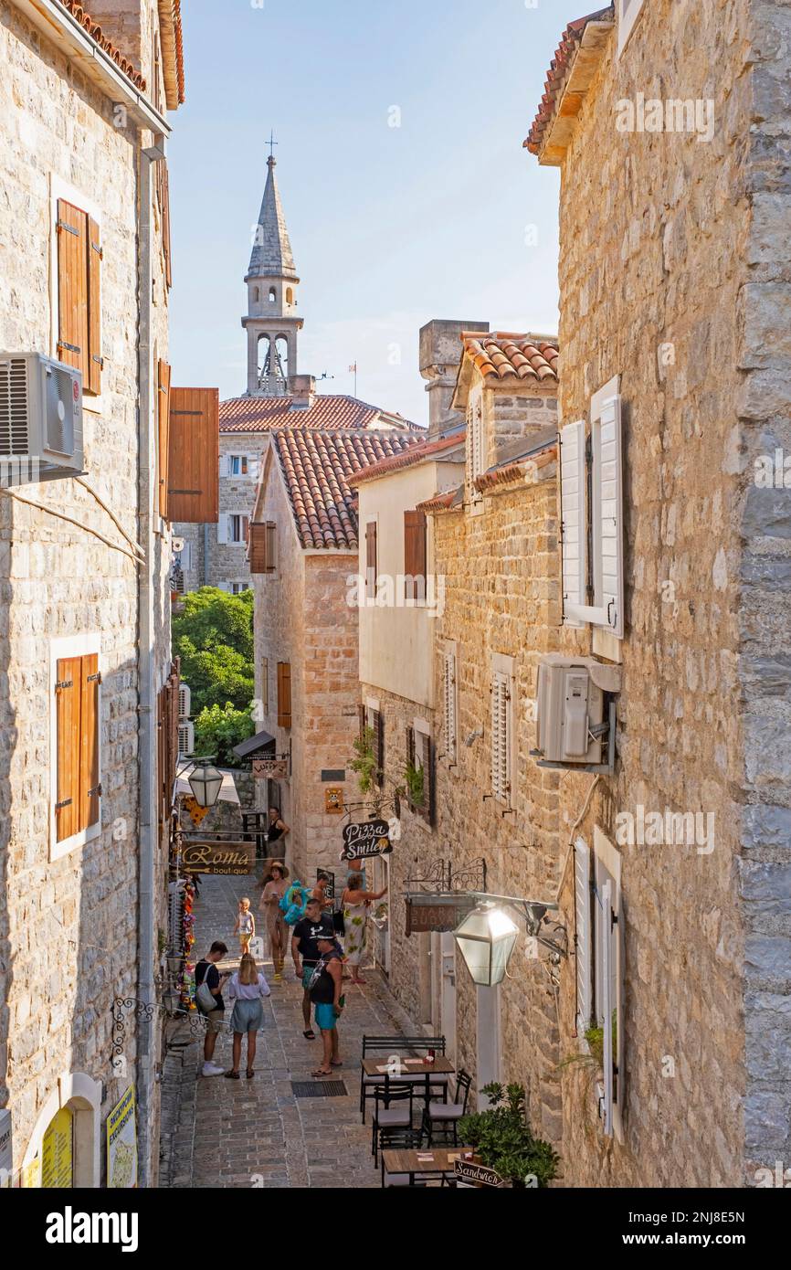 Tourists wandering in narrow alley in the Venetian Old Town Budua at ...