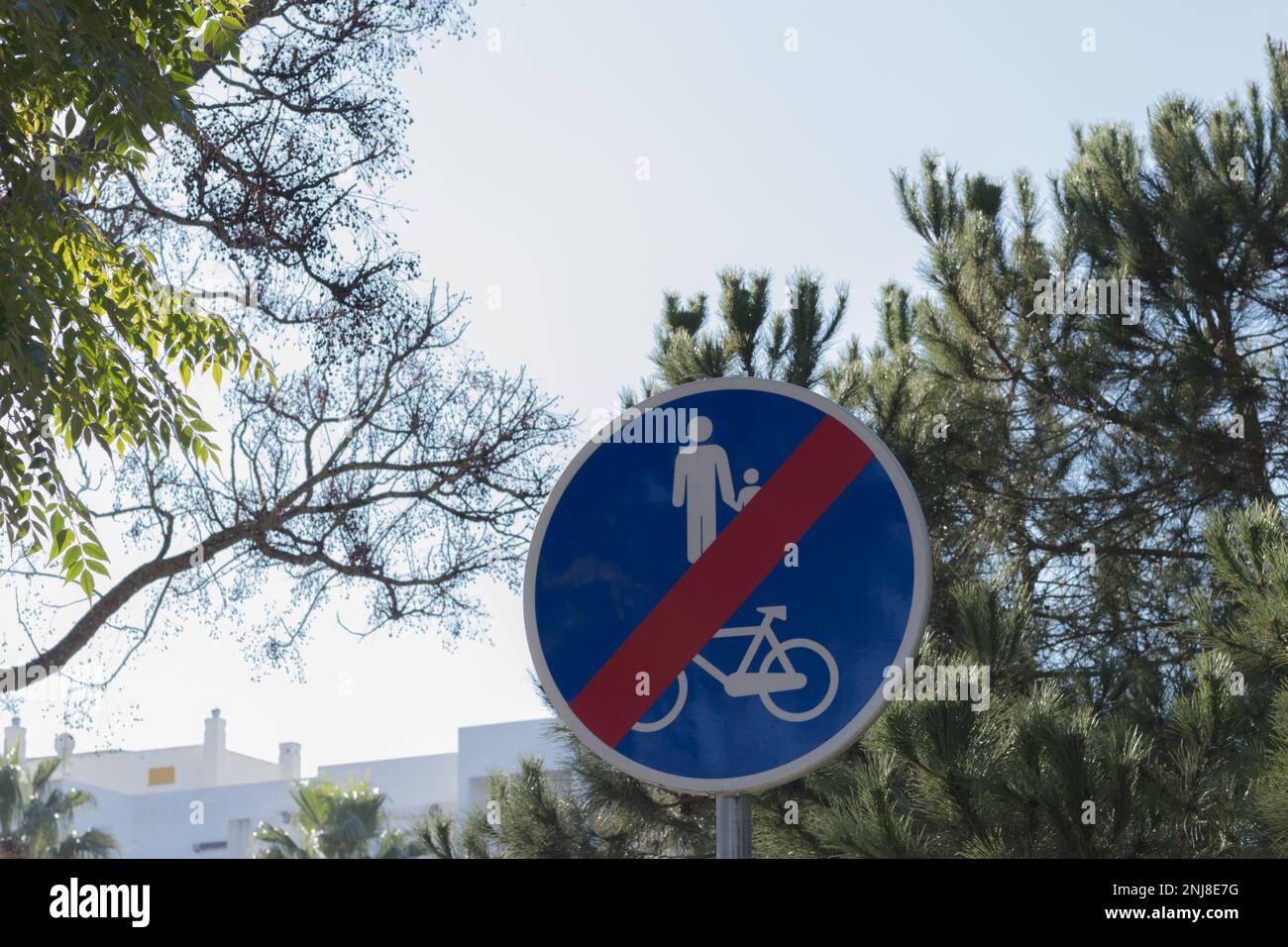 Sign prohibiting cycling and pedestrian passage, against the backdrop ...