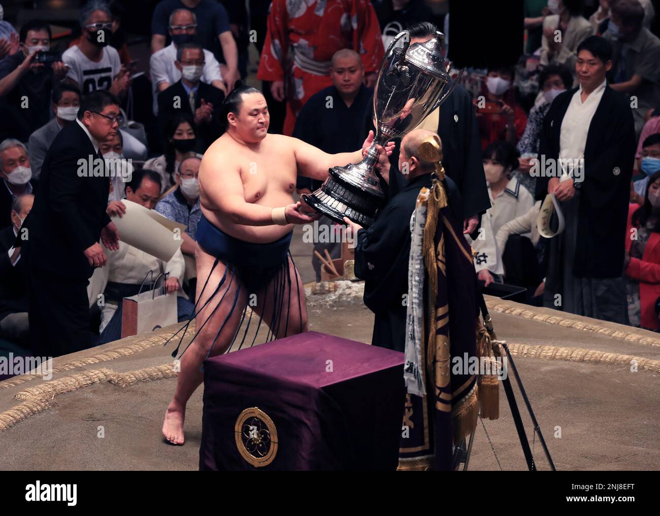 Tamawashi of Mongolia (maegashira #3) receives a championship trophy ...