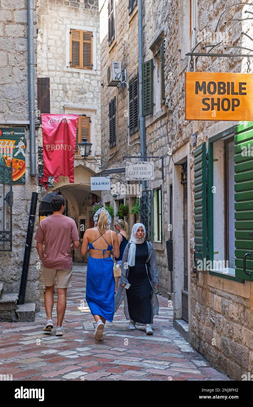 Western tourists and Muslim woman / muslima shopping in narrow alley in ...