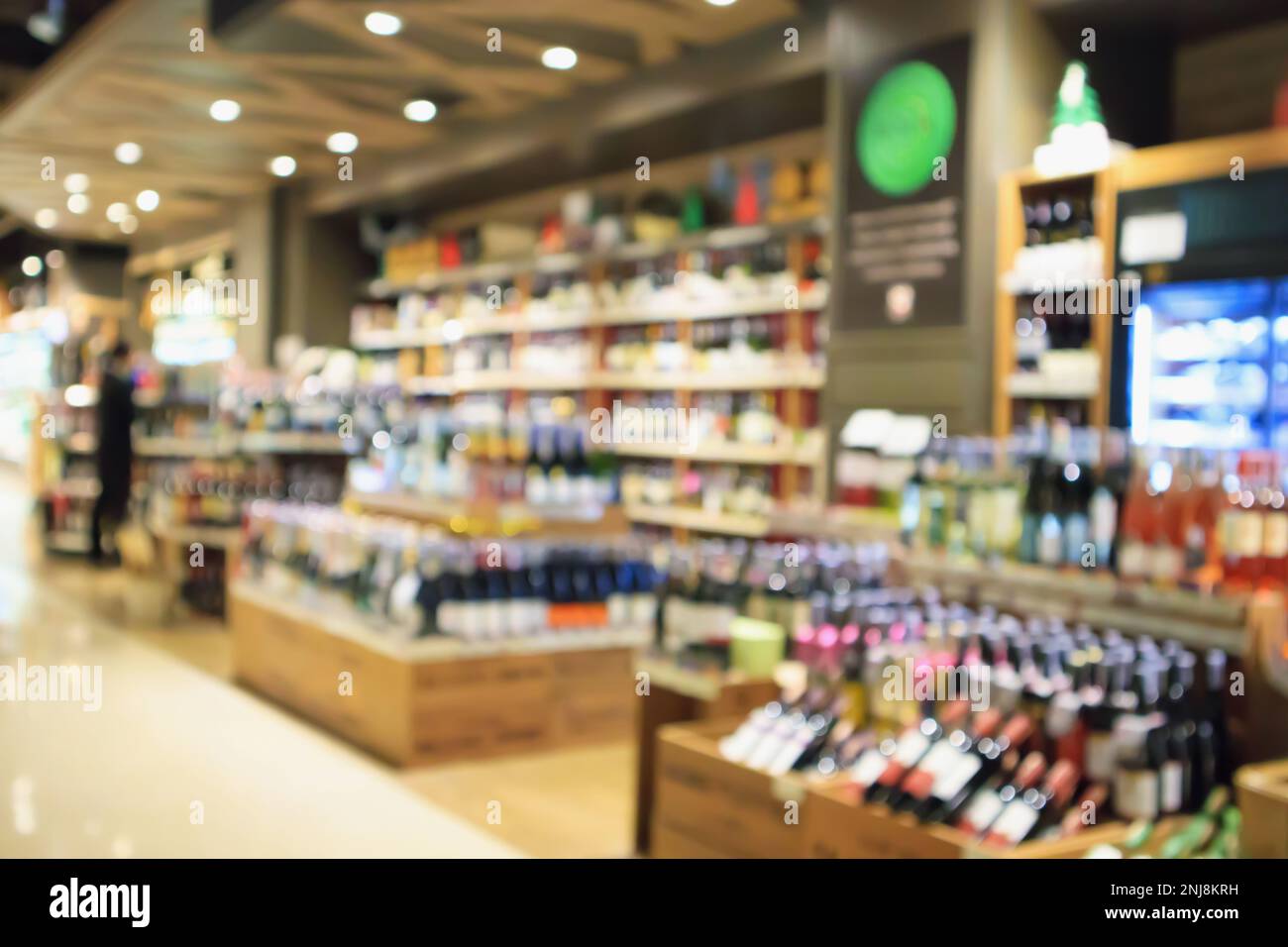 Abstract blur wine bottles on liquor alcohol shelves in supermarket or ...