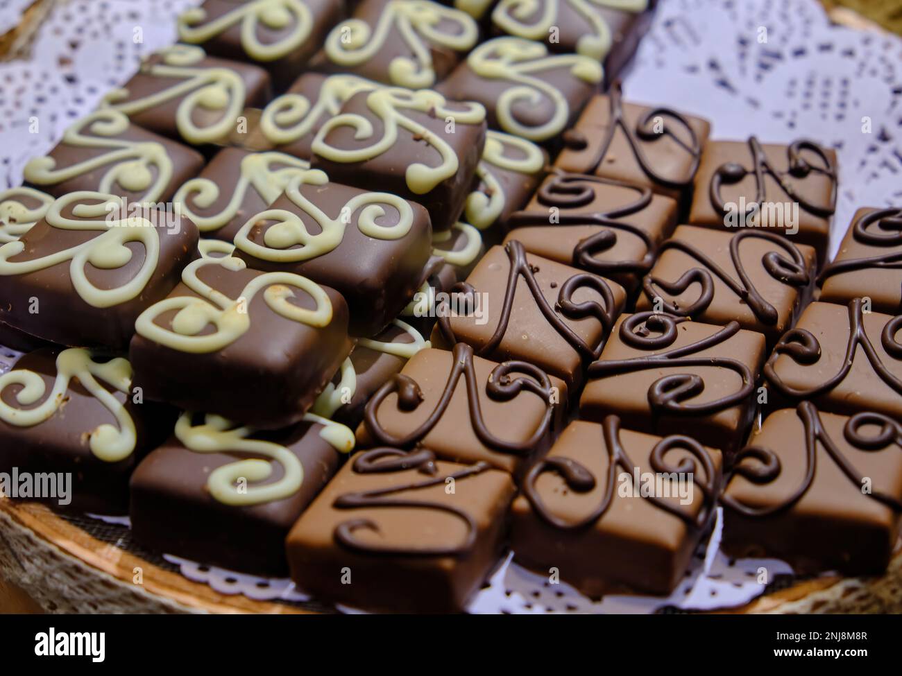 Assorted chocolate candies in a pastry shop, close-up. chocolate nuts ...