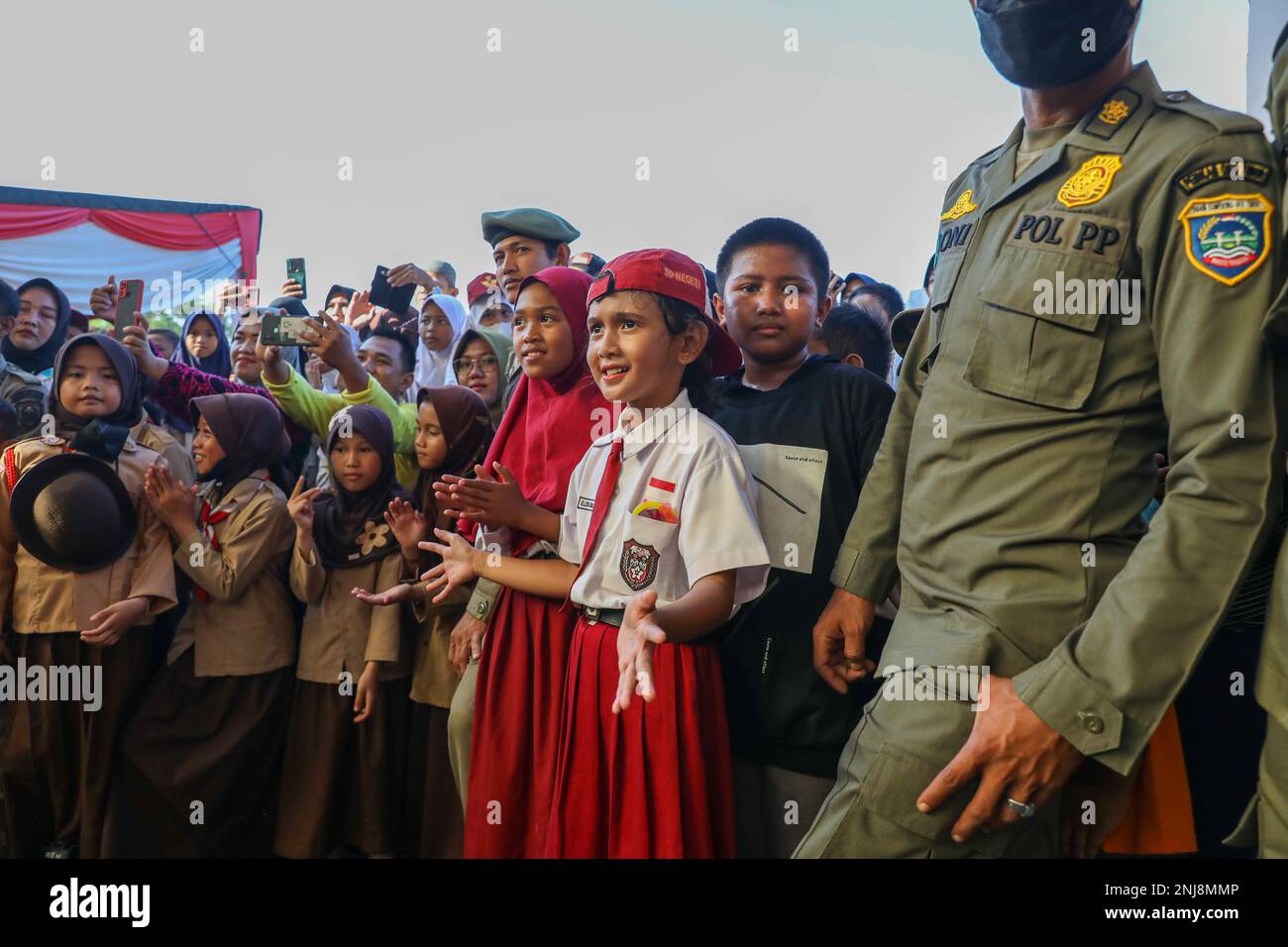 A school girl claps along during a community outreach performance ...
