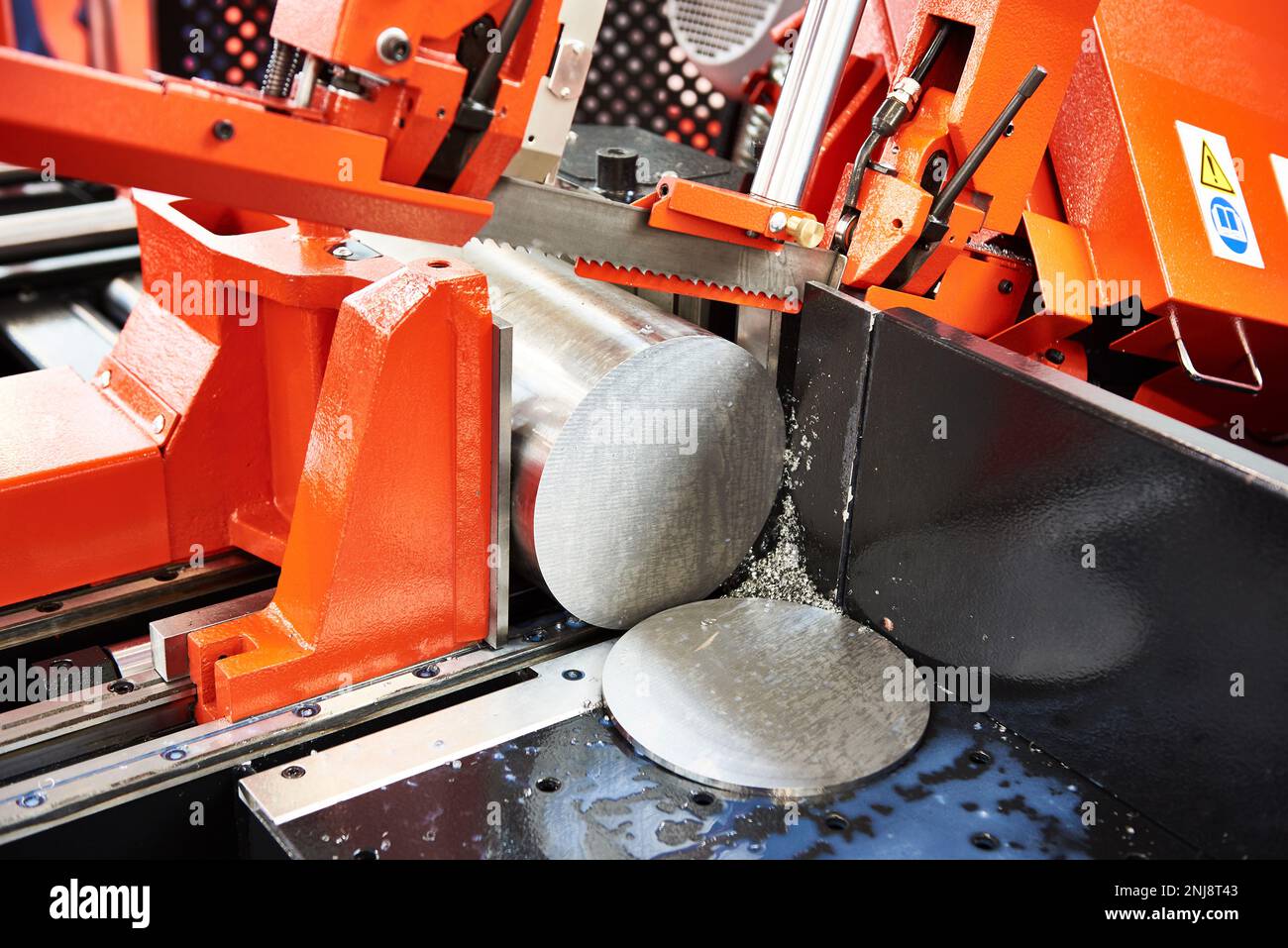 Automatic band saw with a steel workpiece Stock Photo - Alamy