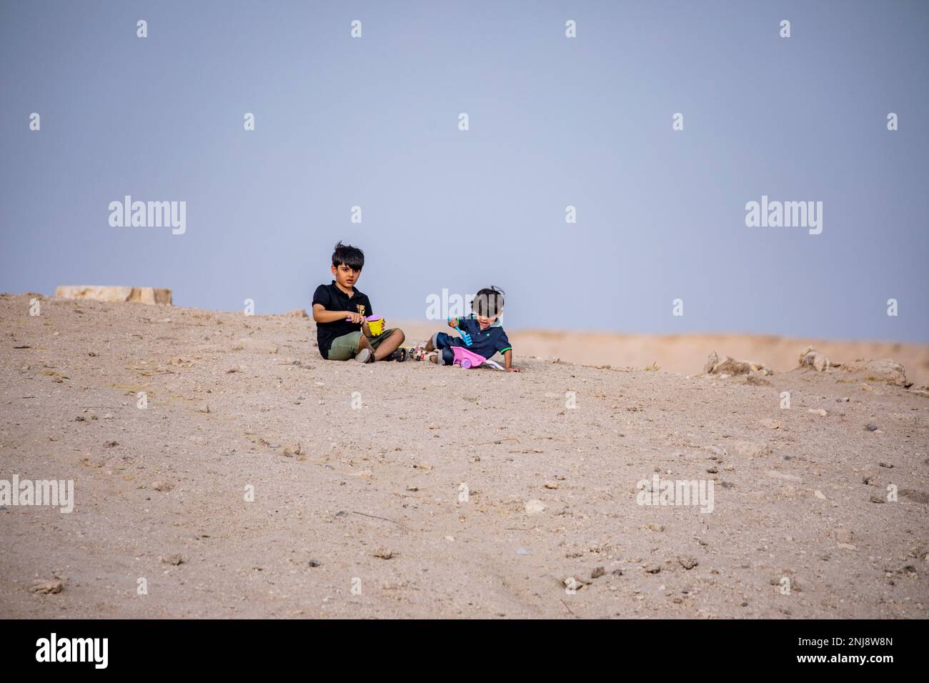 Children play whit sand in the desert in Bahrain Stock Photo - Alamy