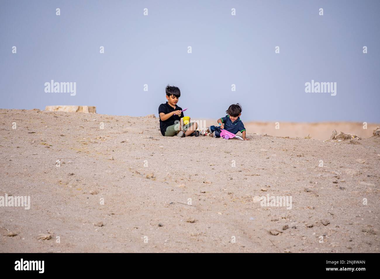 Children play whit sand in the desert in Bahrain Stock Photo - Alamy