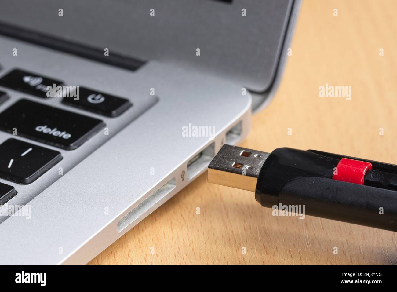 A conceptual photo of plugging in a USB flash drive into a laptop ...