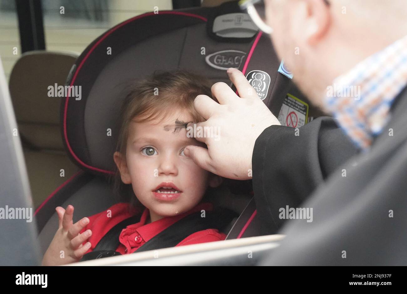 Manchester, United States. 22nd Feb, 2023. Rev. Jim Peich gives ashes ...