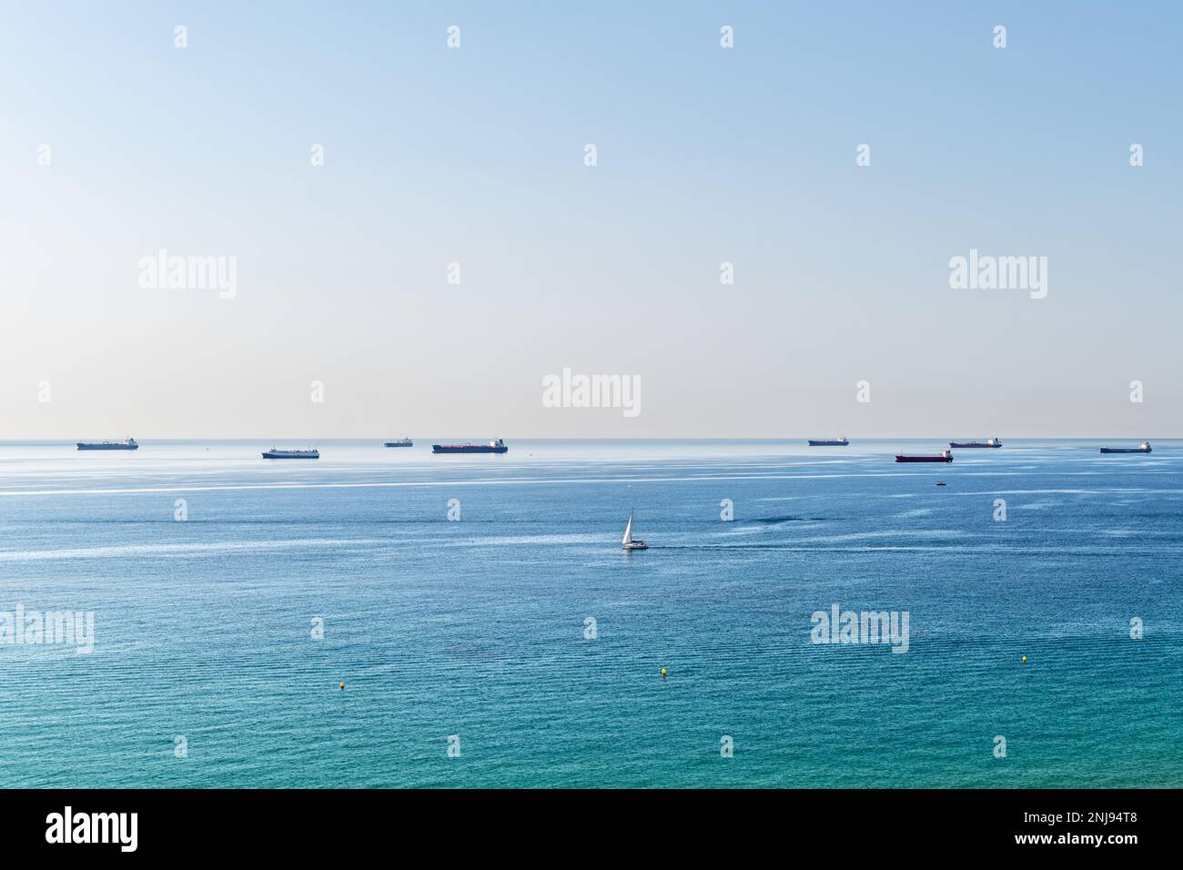 Cargo ships and sailboat outside the port of Tarragona in the ...
