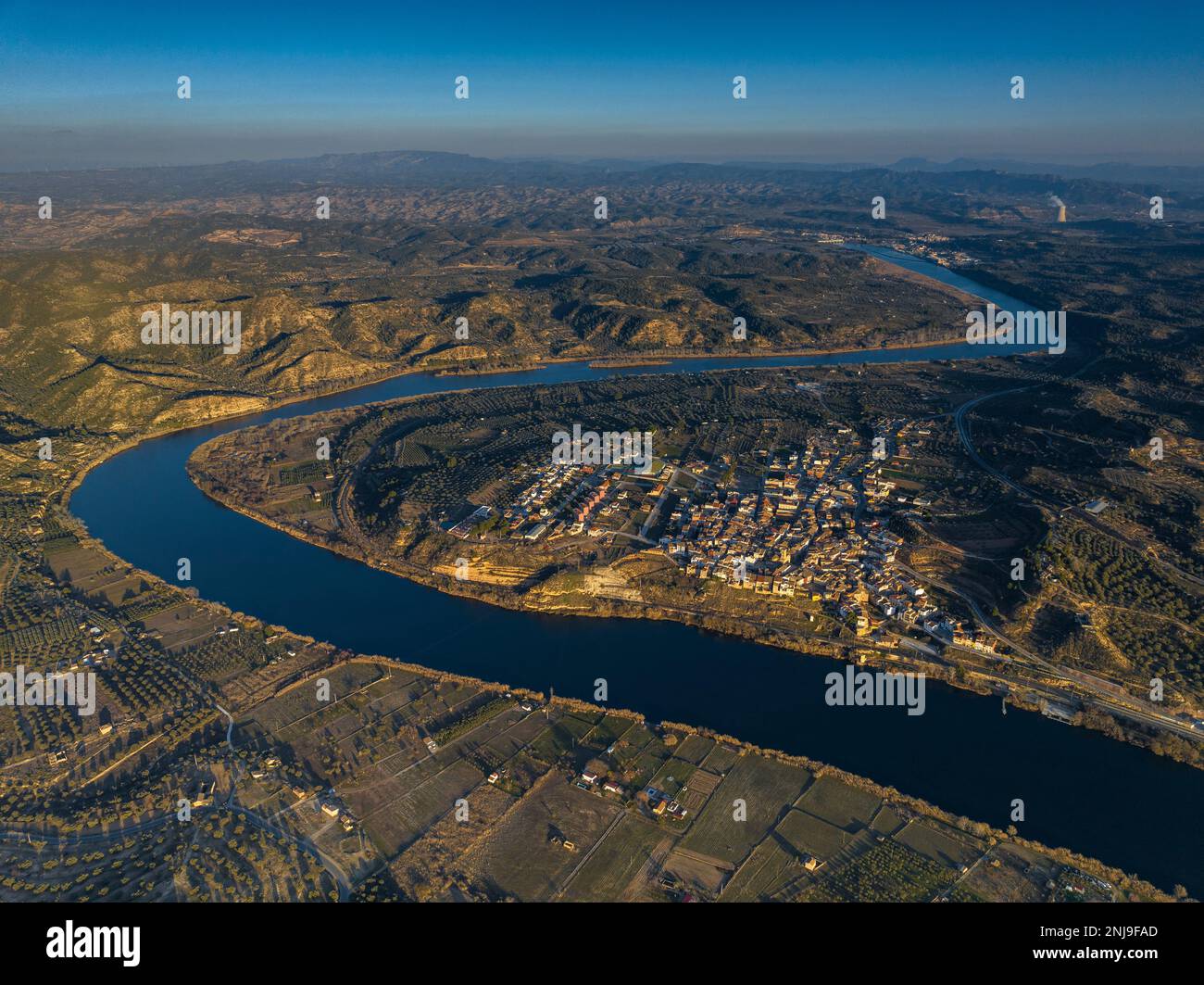 Aerial view of the Ebro river and the town of Riba-roja d'Ebre at ...