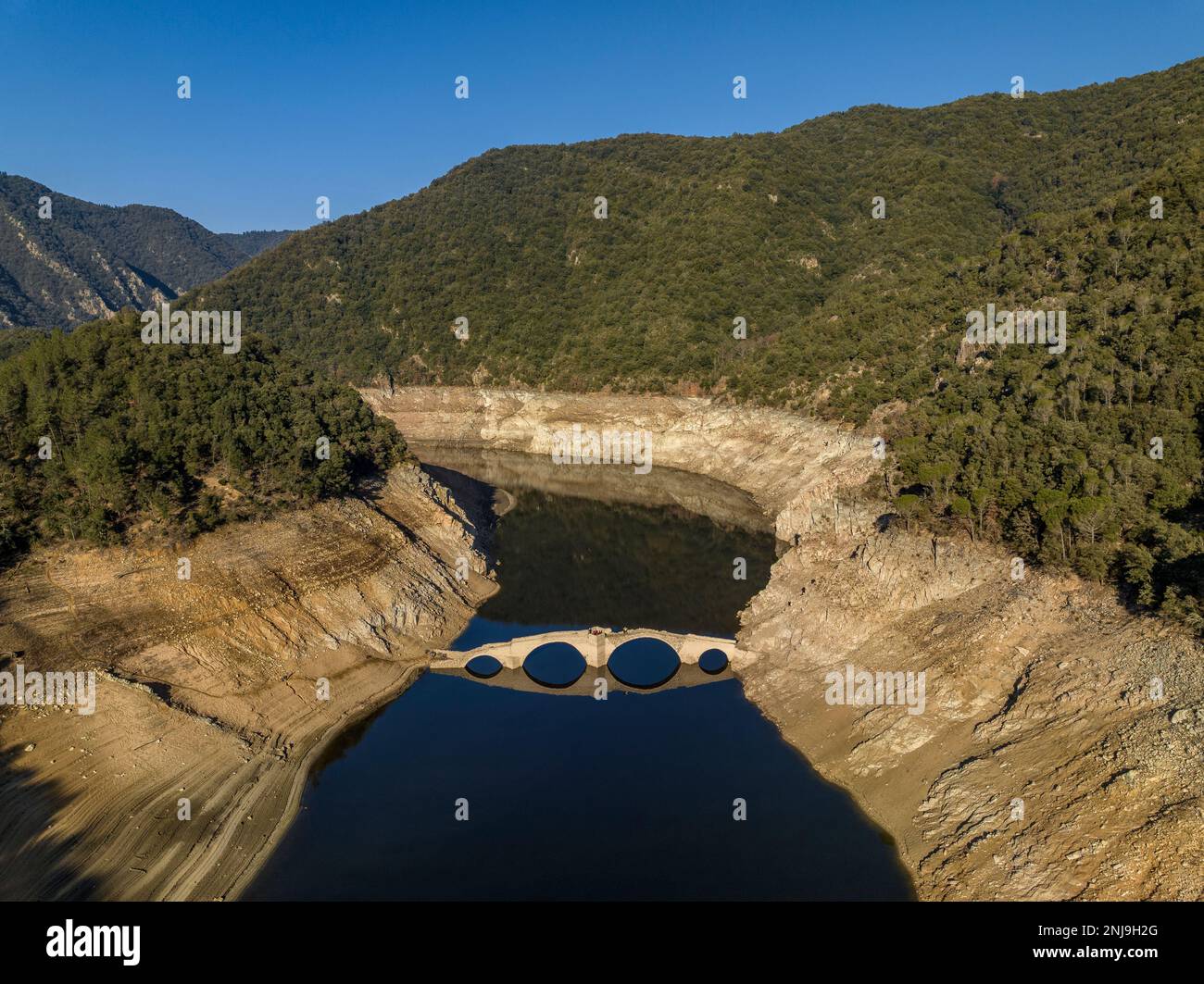 Aerial view of the medieval bridge of Querós, in the Susqueda reservoir ...