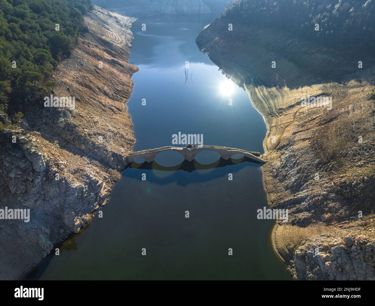Aerial view of the medieval bridge of Querós, in the Susqueda reservoir ...