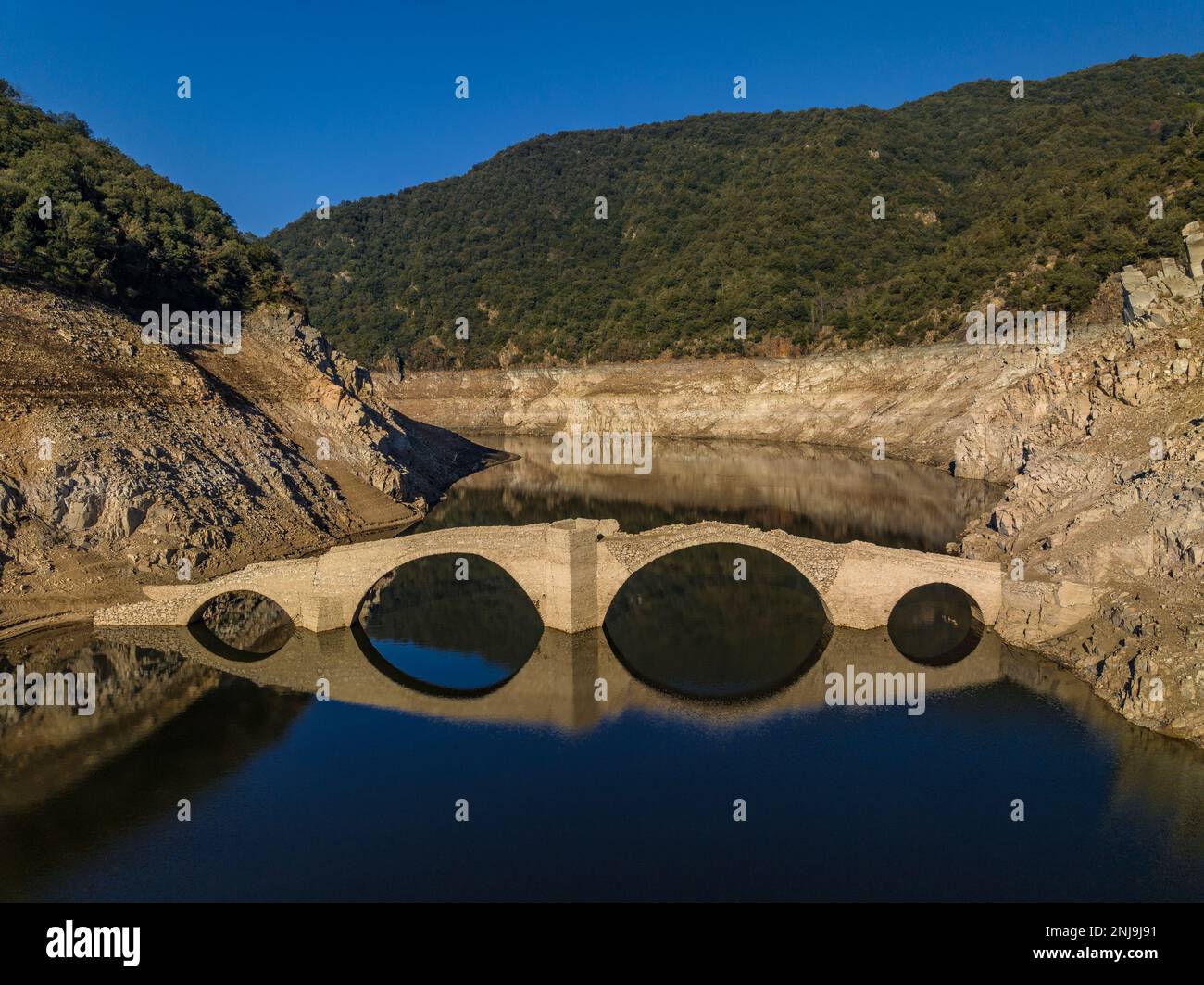 Aerial view of the medieval bridge of Querós, in the Susqueda reservoir ...