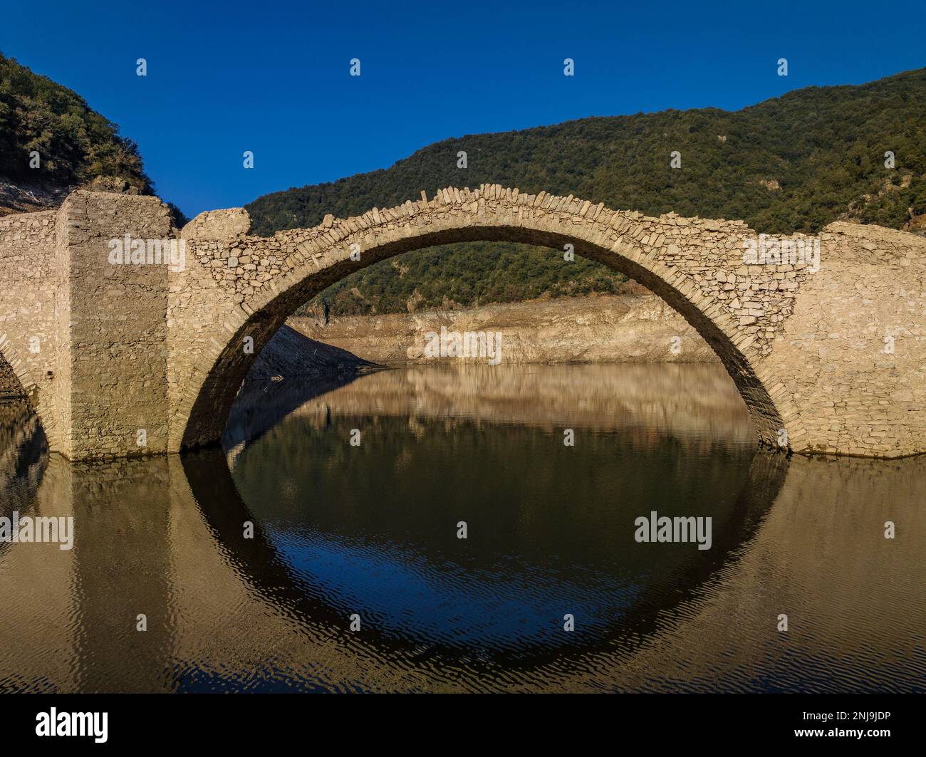 Aerial view of the medieval bridge of Querós, in the Susqueda reservoir ...