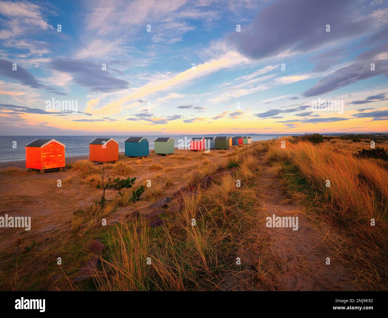 A sandy path leads invitingly through the dunes on Findhorn Beach with ...